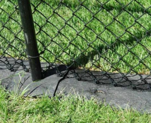 How to Stop Grass and Weeds From Growing Under a Chain Link Fence ...
